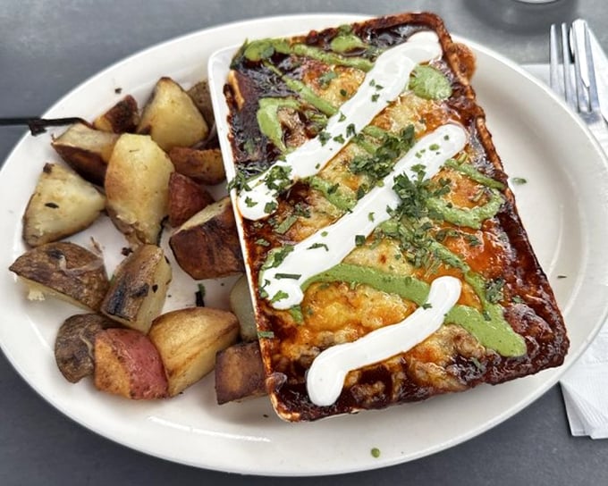 This isn't just breakfast – it's a savory masterpiece topped with avocado and sour cream that makes morning meetings worth canceling.