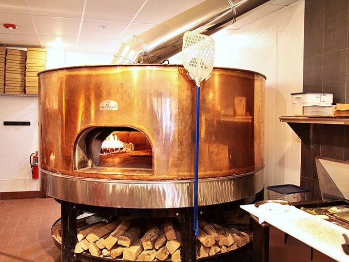 The copper-clad wood-fired oven, glowing with 800-degree intensity, is the heart and soul of Bricks—a culinary time machine to old-world techniques.