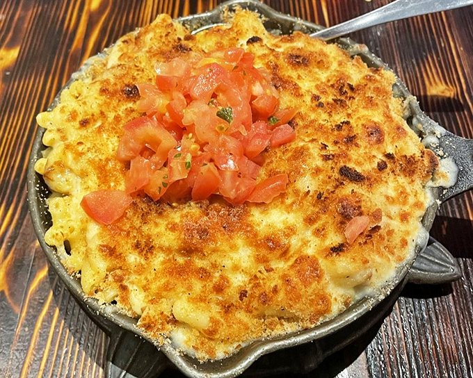 Mac and cheese that's achieved the perfect golden crust—the culinary equivalent of winning the lottery. Those diced tomatoes add a fresh pop of color and flavor.