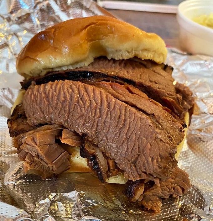 This brisket sandwich isn't just lunch—it's edible architecture where each layer contributes to the perfect bite-to-bite experience.