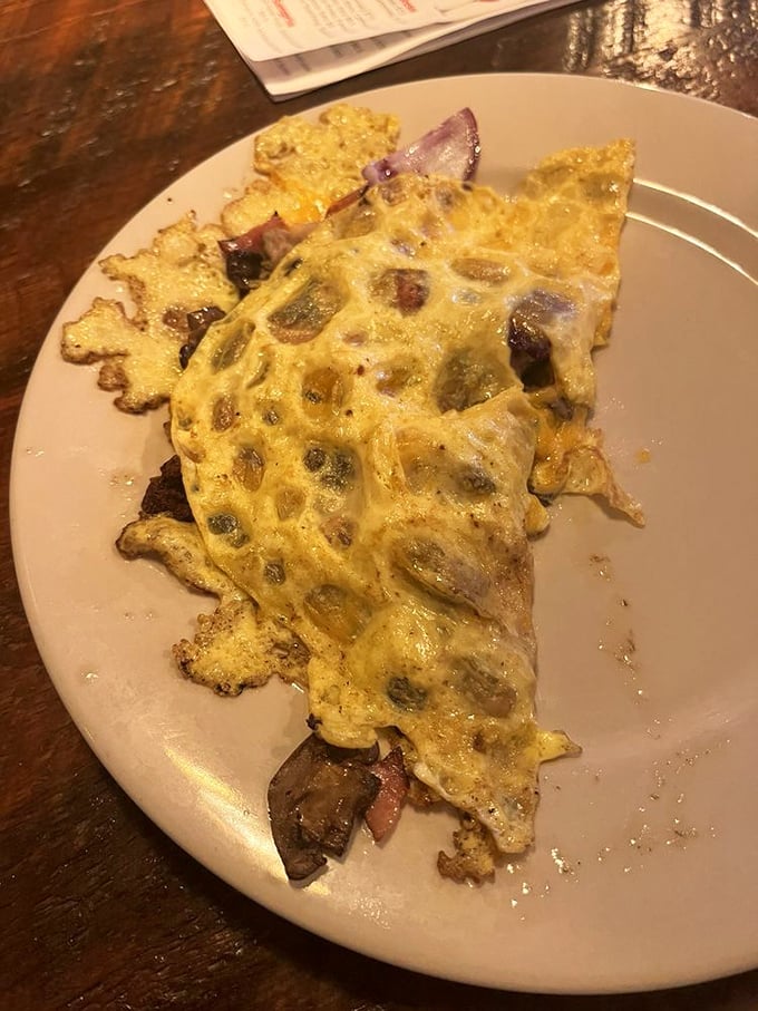 An omelet that's seen things—namely cheese, vegetables, and possibly the meaning of breakfast perfection. Morning glory on a plate.