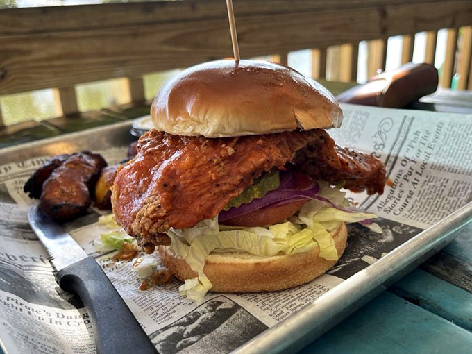 A fried chicken sandwich so substantial it needs a skewer to keep it from toppling. This isn't a sandwich – it's an engineering achievement.