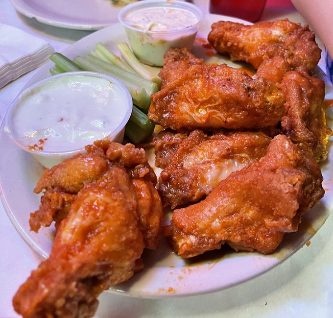 Buffalo wings with the perfect crisp-to-sauce ratio, accompanied by cooling dips and celery sticks—nature's way of making you feel virtuous while indulging.