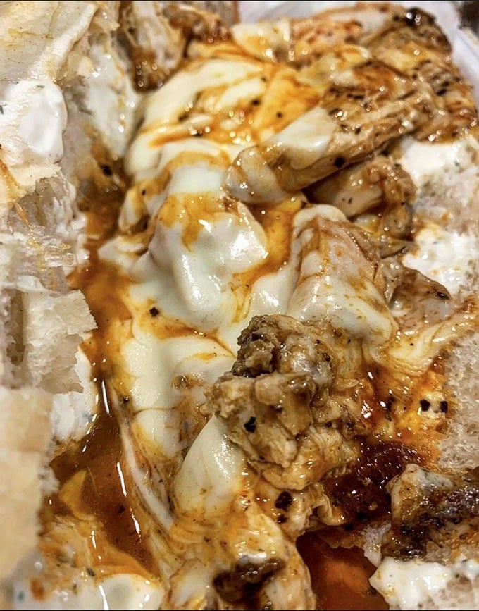 A sandwich where buffalo chicken and melted cheese perform a beautiful duet. The sauce swirls through cheese like a delicious modern art installation.