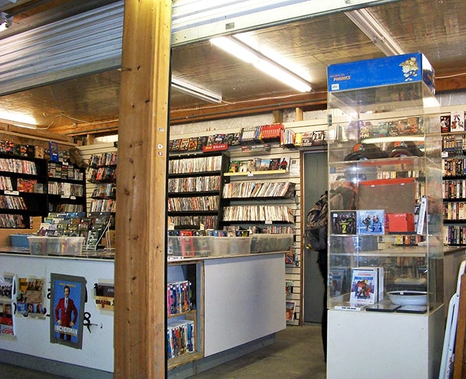 Physical media finds sanctuary in this analog oasis of entertainment. DVDs and CDs line shelves like an archaeological dig through recent pop culture history.