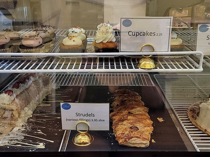 A display case showcasing desserts that whisper sweet temptations to every passing customer nearby.