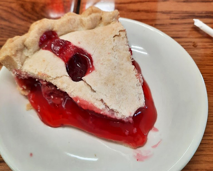 Cherry pie that bleeds ruby red onto the plate—nature's candy wrapped in a crust that shatters just right.