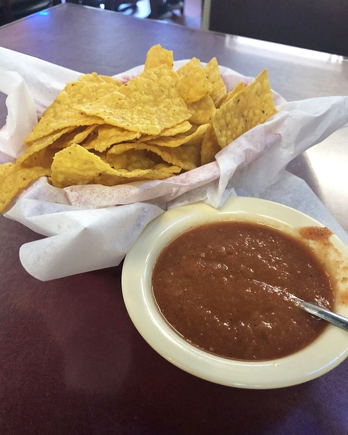 Chips and salsa – the opening act that sometimes steals the show. These homemade tortilla triangles are merely vehicles for that smoky, spicy condiment perfection.