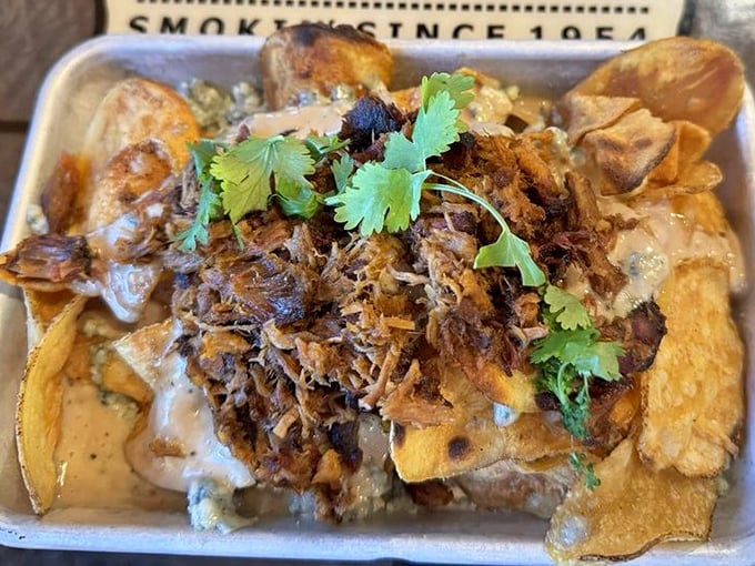 Not just nachos—a mountain range of chips, cheese, and pulled pork where every bite is a tiny vacation. The cilantro adds that perfect fresh counterpoint.