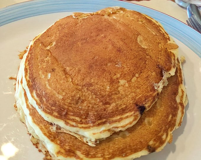 Pancakes stacked like golden discs of happiness—the kind that make you wonder why anyone would ever skip breakfast.