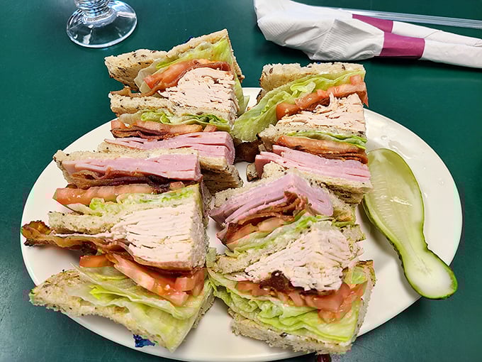 This club sandwich isn't playing around—layers of turkey, ham, and bacon create a skyscraper of satisfaction that requires serious jaw strategy.