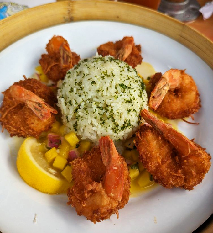 Coconut shrimp arranged like edible flowers around herb-kissed rice – when presentation meets pure deliciousness.