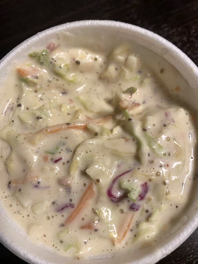 This isn't just coleslaw—it's a creamy, crunchy counterpoint to all that smoky meat, with hints of purple onion playing hide and seek.