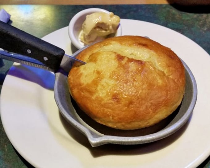 Cornbread served in a hot skillet with a side of butter that's melting faster than your willpower – a Southern tradition that feels like a warm hug.