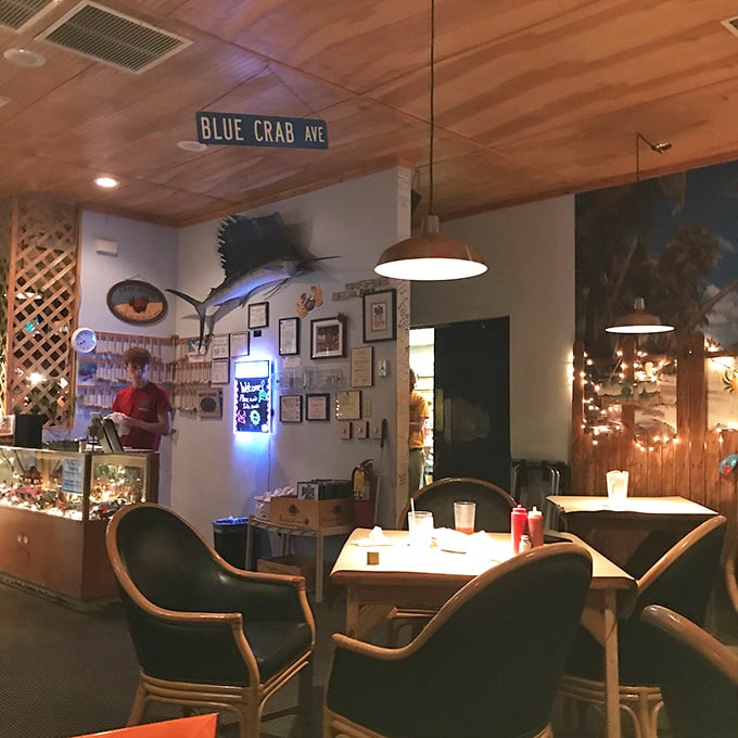 Another dining area showcases maritime treasures and the signature "Blue Crab Ave" sign—casual elegance with a side of coastal charm.