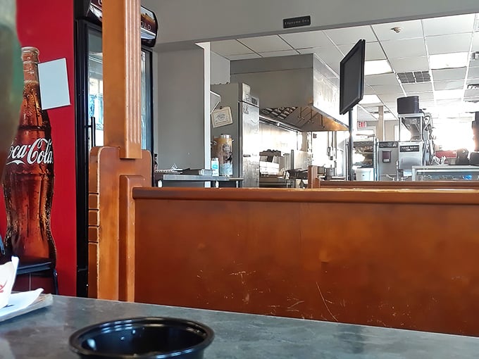 Simple wooden booths and Coca-Cola signs—the universal language of "good food happens here" that needs no translation.