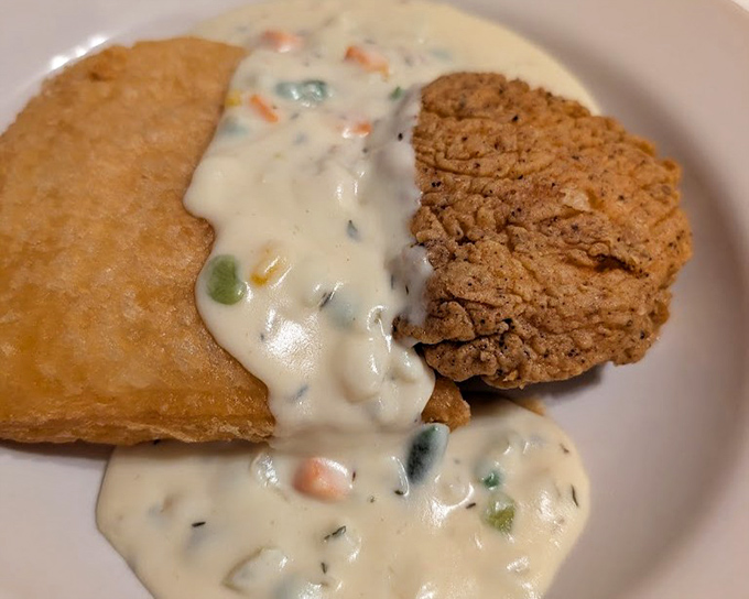 Country fried steak swimming in creamy vegetable-studded gravy – when a dish requires both a fork and a spoon, you know you're in for something special.