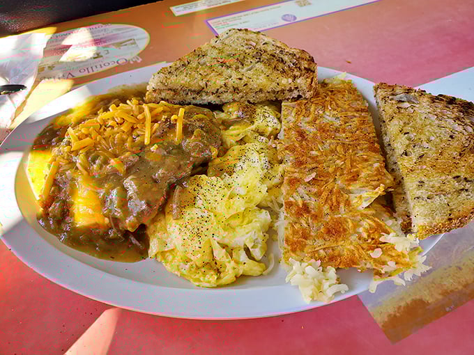 Country fried steak swimming in gravy with eggs and hash browns—the breakfast equivalent of a warm hug from your favorite aunt.