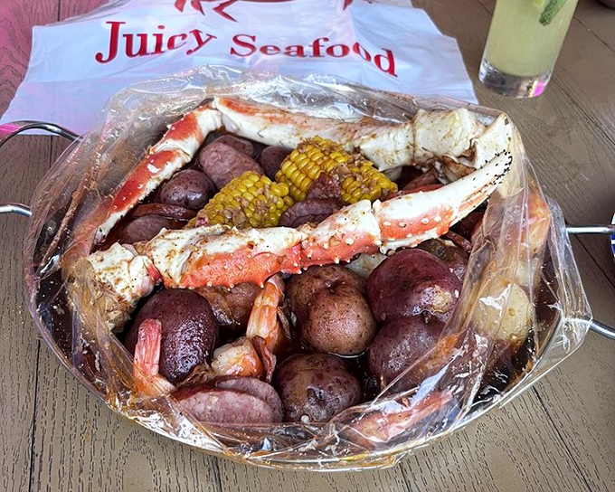 The plastic bag presentation isn't fancy, but what's inside is pure seafood royalty. Crab legs, potatoes, corn—a complete ecosystem of flavor.