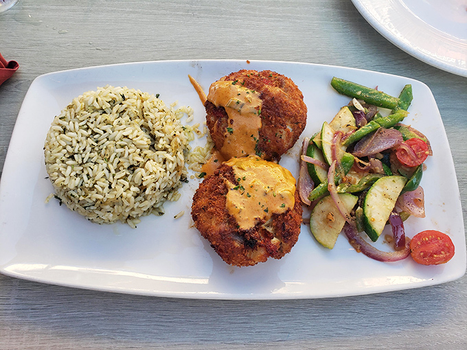 These crab cakes aren't just generous—they're philanthropic. The rice and vegetables provide the illusion that you're making healthy choices. 