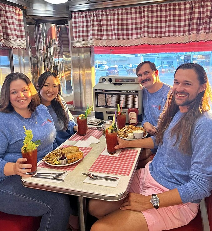 Happy diners with Bloody Marys that could double as salad bars—garnished with enough celery to count as a vegetable serving.