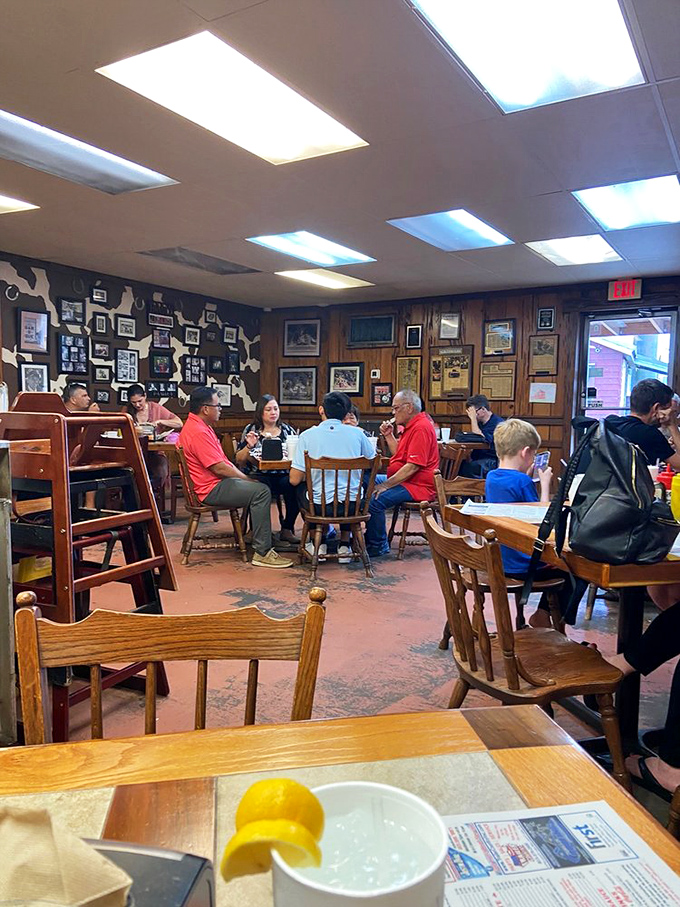 The dining room hums with the universal language of BBQ appreciation. Those wooden chairs have supported generations of happy eaters.