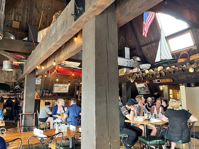 The bustling dining room hums with conversation and clinking glasses—proof that good food brings strangers together under rustic beams and string lights.