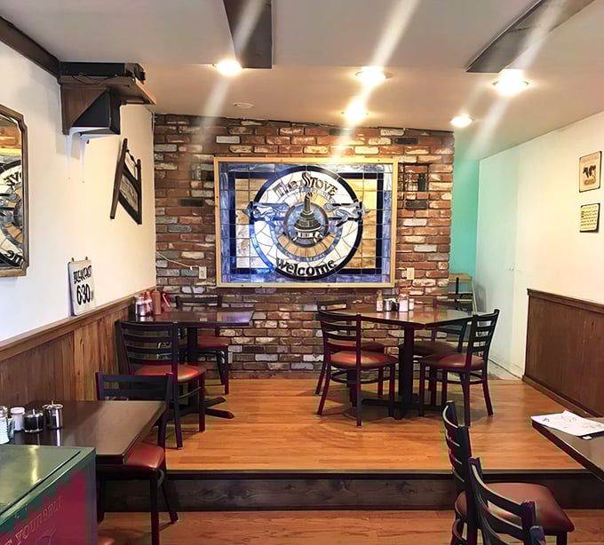 That stained glass stove emblem against exposed brick isn't just decoration—it's a shrine to the breakfast arts that keeps Californians making the mountain pilgrimage.