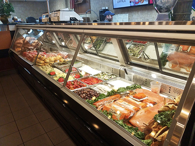 This display case isn't just refrigerated—it's a museum of deliciousness. Each salad and slice of fish arranged with the precision of fine art.