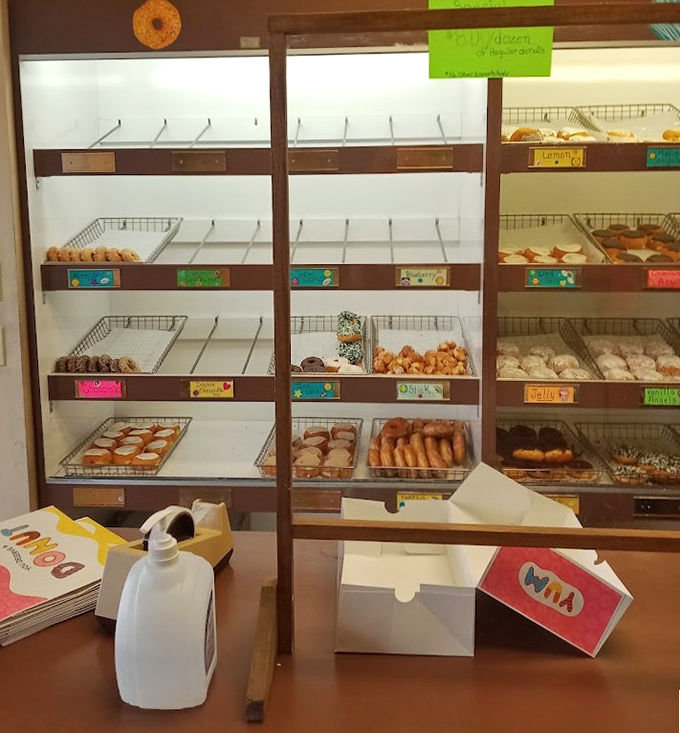 Half-empty shelves tell the story of a busy morning—in the donut world, popularity means you might miss out if you hit snooze too many times.
