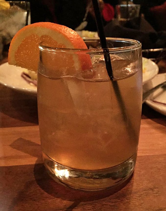 The Early Riser cocktail with its citrus garnish – because sometimes the perfect Manhattan needs a Southern vacation.