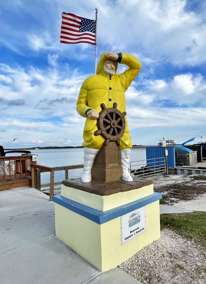 This yellow fisherman statue isn't just decoration—he's the unofficial mayor of Goodrich, keeping watch over the lagoon and hungry visitors alike.