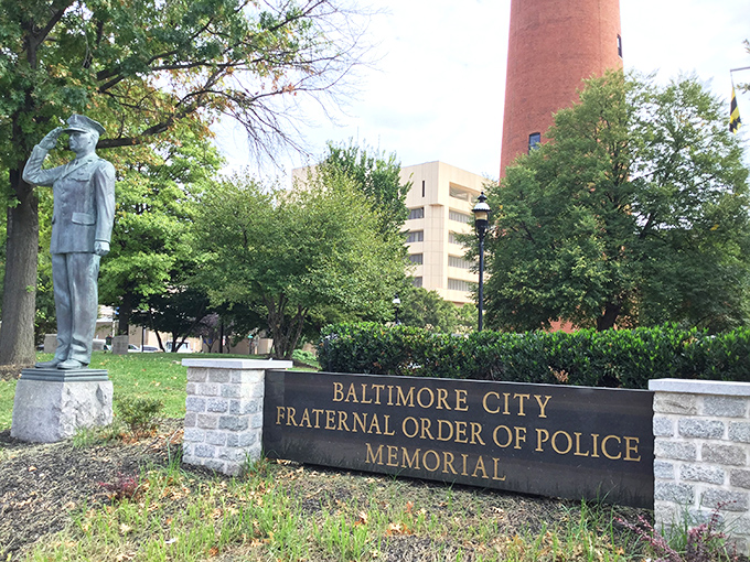 The Police Memorial shares the landscape with the Shot Tower—different centuries, same dedication to preserving Baltimore's complex story.