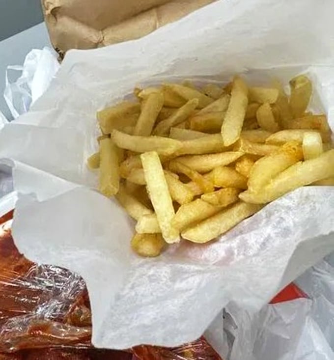Golden fries nestled in paper – the perfect supporting actor to the BBQ star of the show, ready to soak up any wayward sauce.
