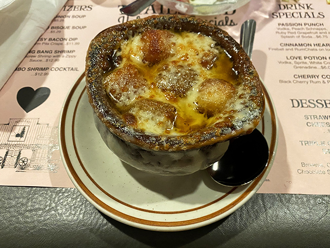French onion soup with a golden crown of bubbling cheese—a bowl of comfort that's worth the inevitable chin dribble.