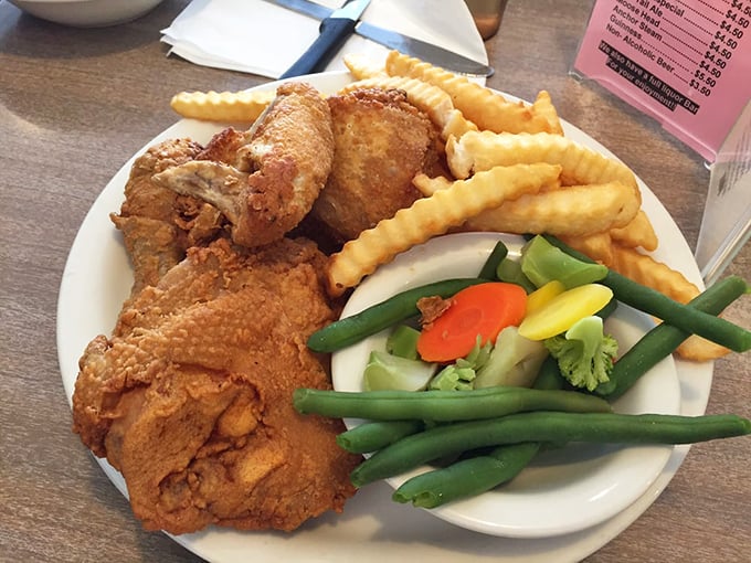 Fried chicken with the golden ratio of crispy coating to juicy meat, served with crinkle fries and vegetables pretending to make this a balanced meal.