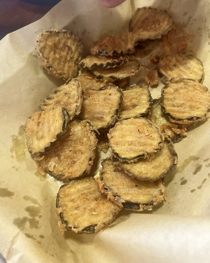 Fried zucchini coins—crispy, golden-brown treasures that somehow make vegetables feel like an indulgence. Vegetable virtue with deep-fried vice.