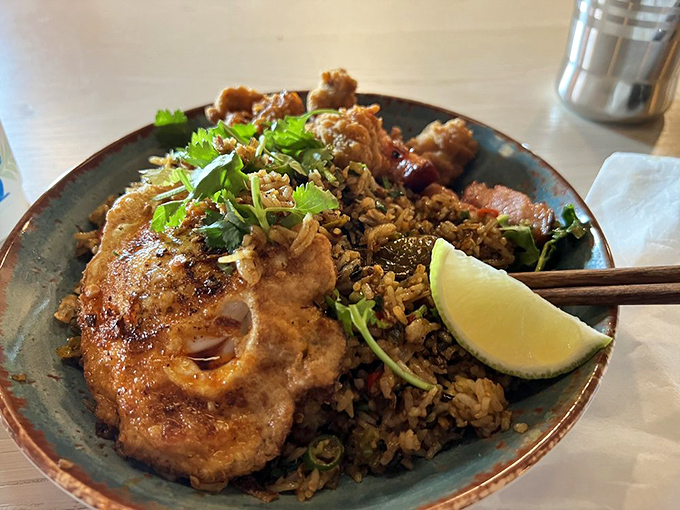 Fried rice elevated to main character status, with protein and herbs playing supporting roles in this bowl of comfort.