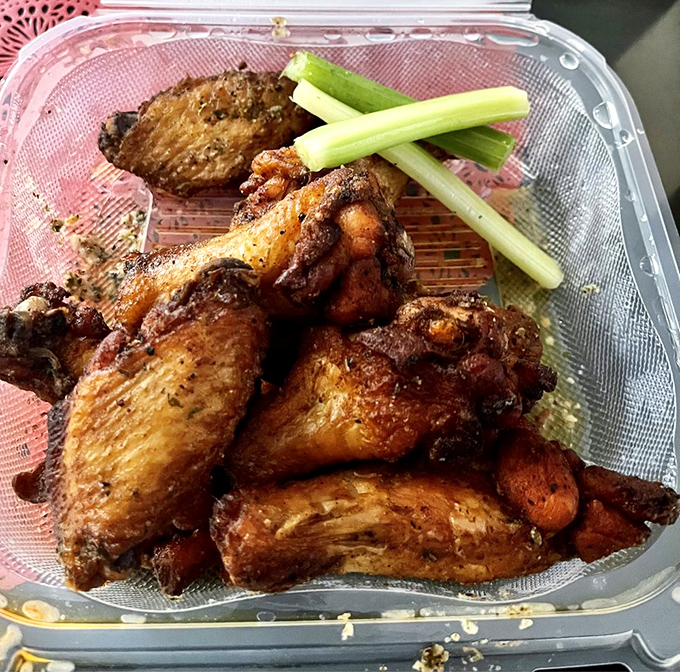 Wings that have clearly been introduced to spices and heat on a first-name basis. The celery sticks are just there as witnesses.