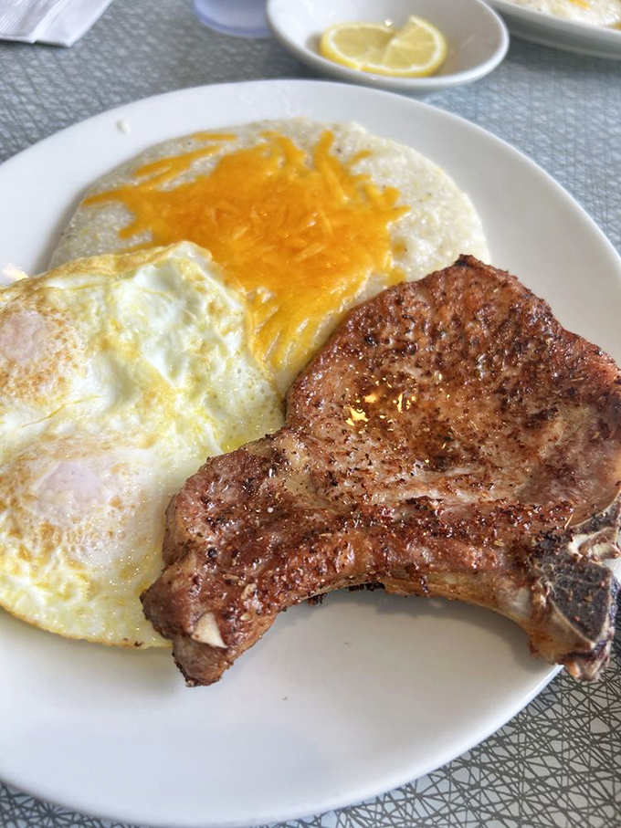 A pork chop and eggs plate that doesn't need Instagram filters—just your undivided attention and an empty stomach.