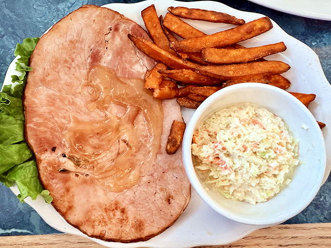 Ham steak that's living its best life with those sweet potato fries and coleslaw. This is what pigs dream of becoming when they grow up.