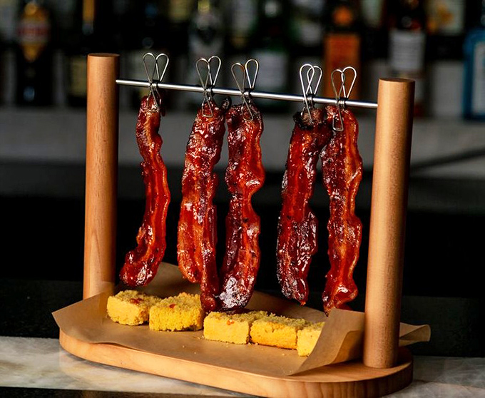 Bacon displayed like fine jewelry, because that's exactly what it is. Those cornbread squares aren't just sides—they're edible napkins for the bacon journey ahead.