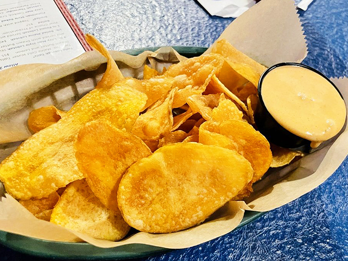 House-made potato chips with a side of what appears to be remoulade—a humble snack elevated to addiction status through perfect execution.