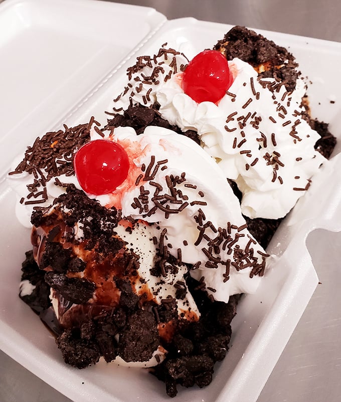 This hot fudge brownie creation isn't just dessert—it's therapy in a styrofoam container, complete with medicinal maraschino cherries.