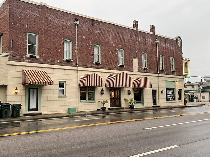 Hotel DeFuniak's striped awnings add a touch of Parisian charm to small-town Florida. Hospitality with architectural character to match.