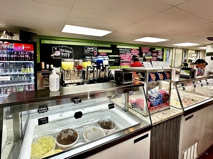 The display case—where dreams and diet plans come to negotiate terms. Those toppings are just waiting to jump onto your scoop.