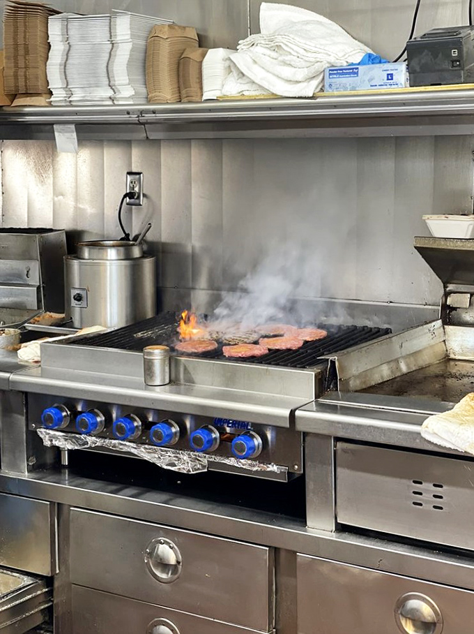 Where the magic happens – patties sizzling on an open flame in the time-honored tradition that no fancy cooking technique can improve upon.