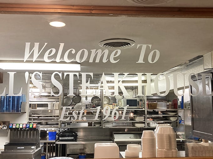 "Welcome To Bill's Steak House Est. 1961" – where six decades of steak expertise awaits behind spotless kitchen glass.