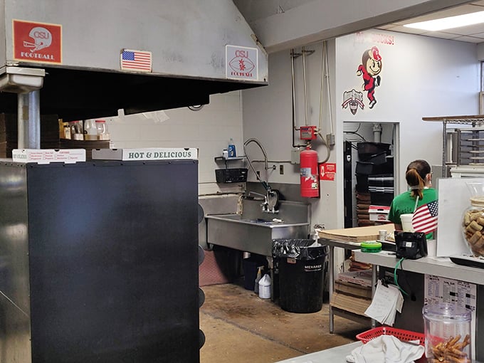 No fancy kitchen stadium here—just the honest workspace where Italian-American magic happens. Those OSU decorations remind you exactly where you are.