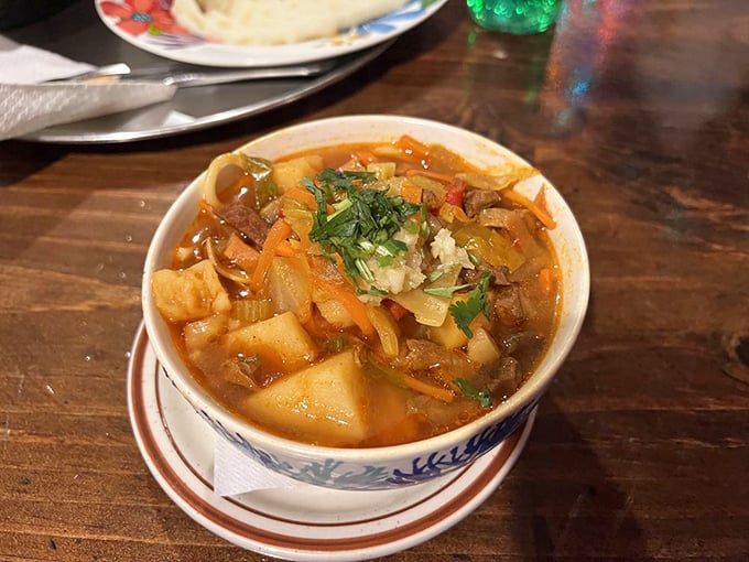 This hearty stew doesn't just warm your stomach—it hugs your soul. Chunks of potato and meat swimming in a broth that's been simmering since before you made reservations.